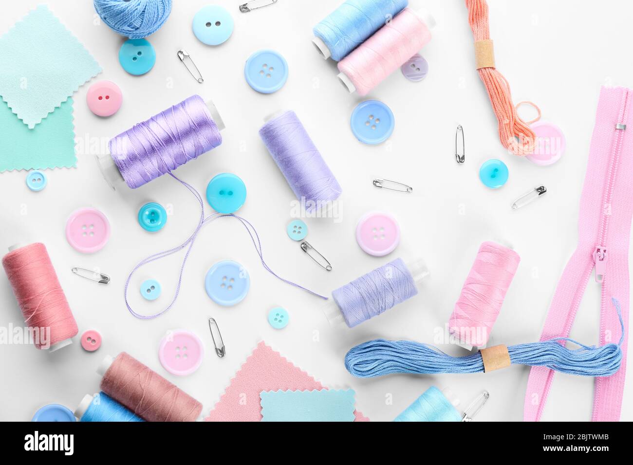 Composition with sewing threads and accessories on white background ...