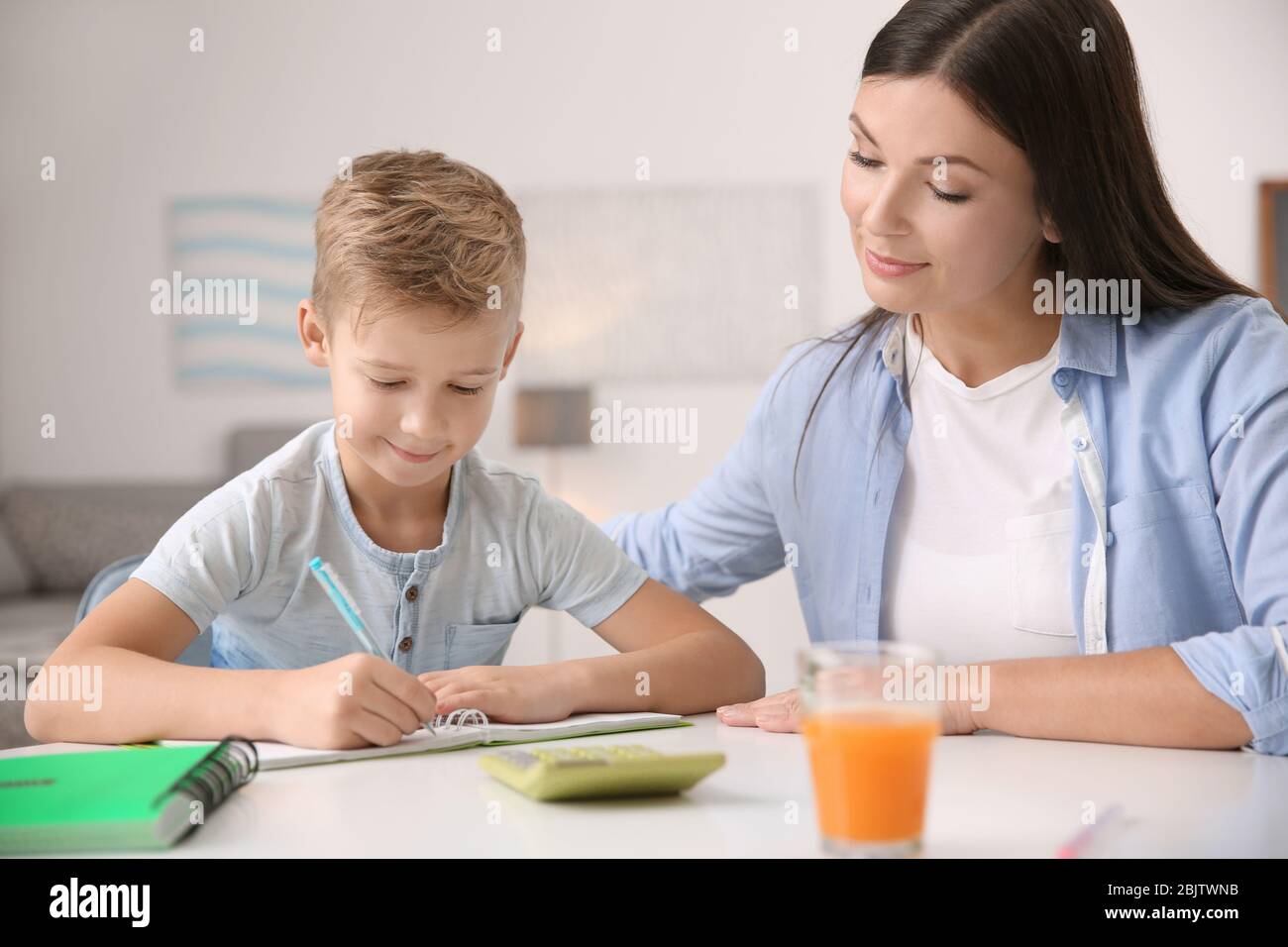 Cute mother son doing homework hi-res stock photography and images - Alamy