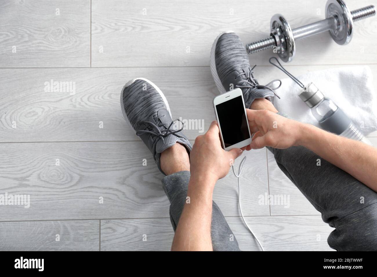 Man using smartphone in gym, top view Stock Photo - Alamy