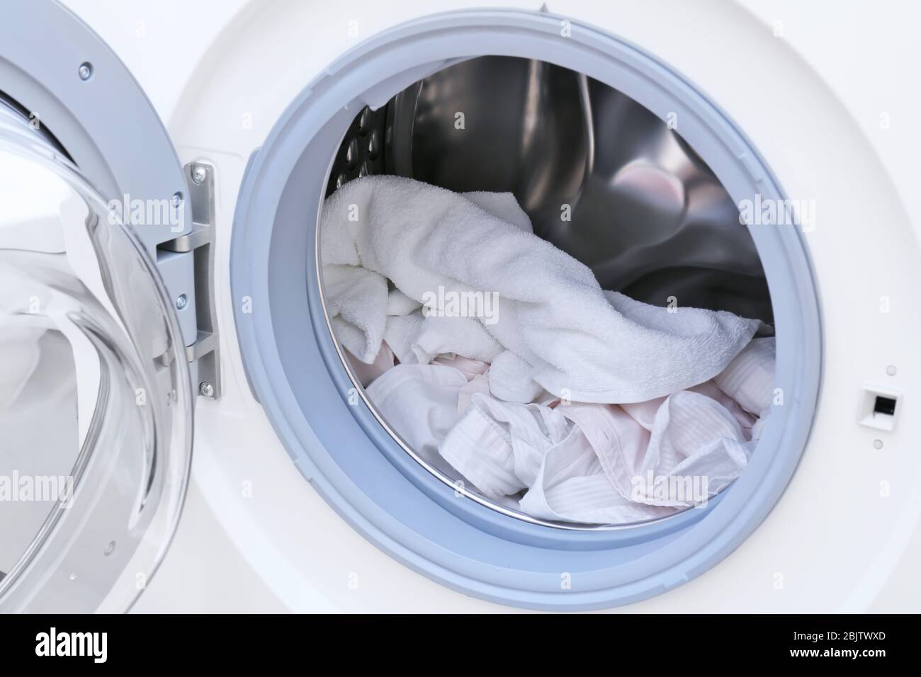 Washing machine with clothes, closeup. Laundry day Stock Photo - Alamy