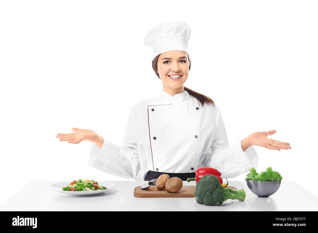 Female chef near table with products against white background Stock ...