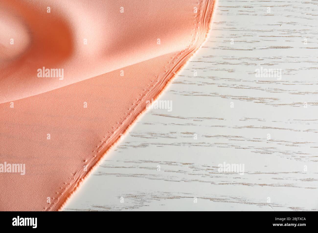 Apricot textile on light background. Fabric texture Stock Photo - Alamy