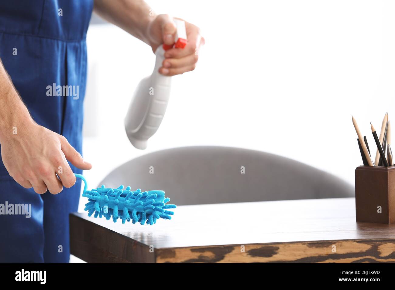 Young man cleaning table with duster, closeup Stock Photo - Alamy