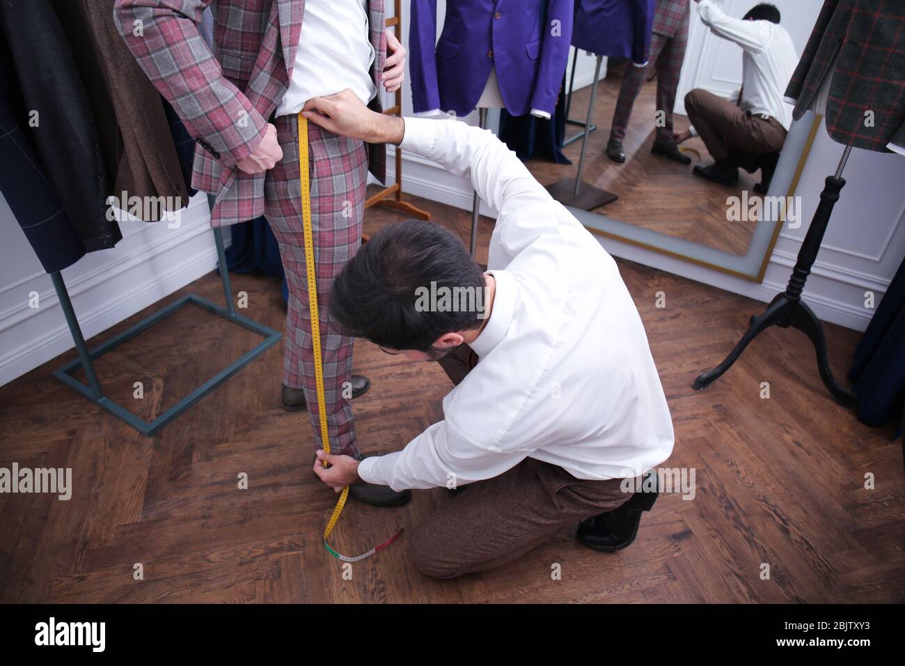 Tailor measuring pants hi-res stock photography and images - Alamy