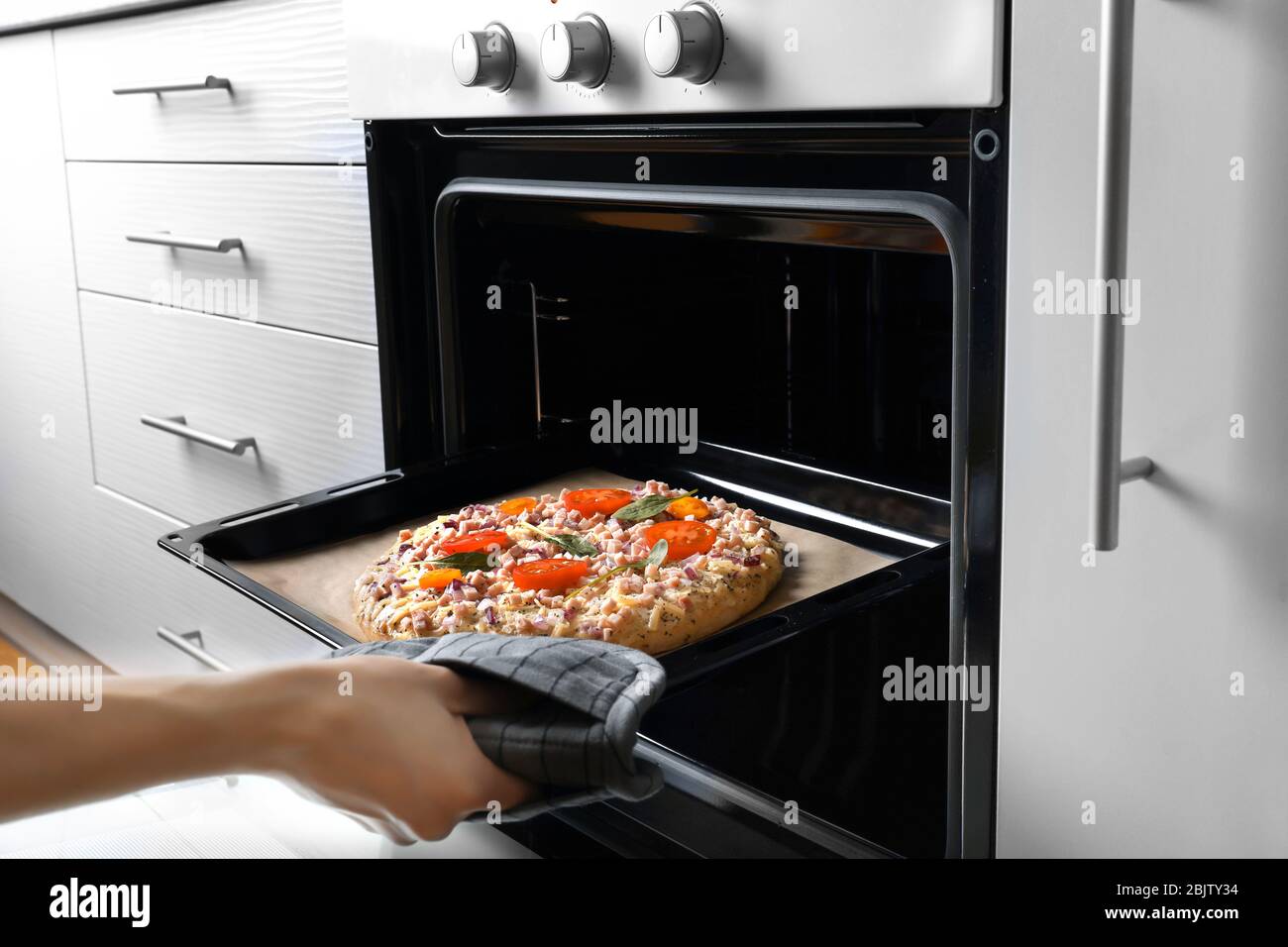 Woman putting homemade pizza hi-res stock photography and images - Alamy
