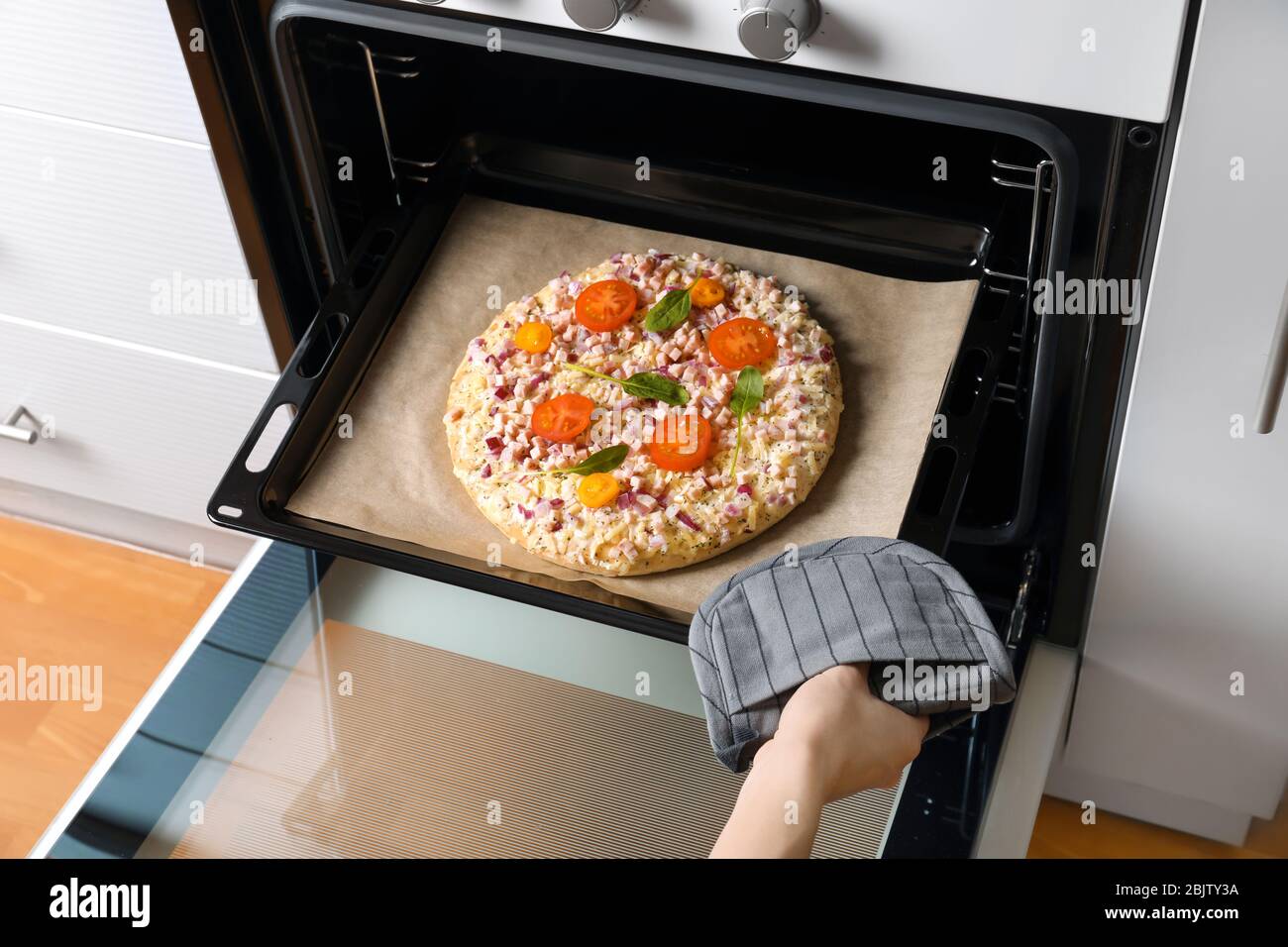 Woman putting homemade pizza hi-res stock photography and images - Alamy