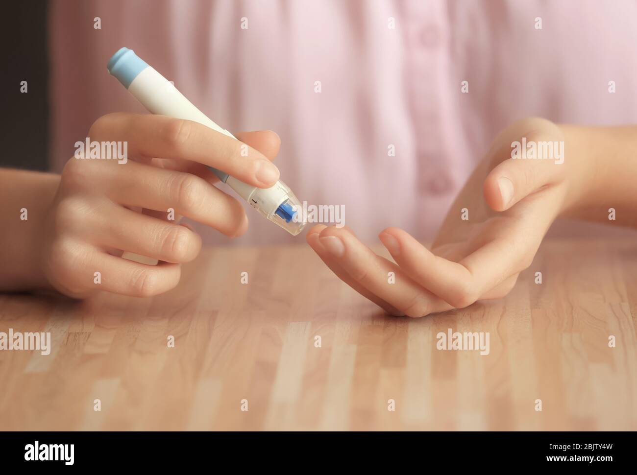 Diabetic woman taking blood sample with lancet pen, closeup Stock Photo ...