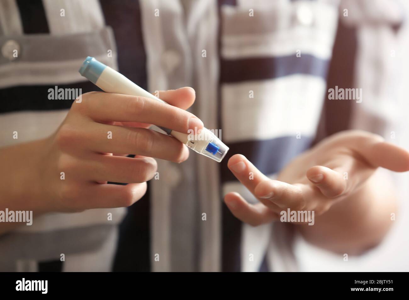 Diabetic woman taking blood sample with lancet pen, closeup Stock Photo ...