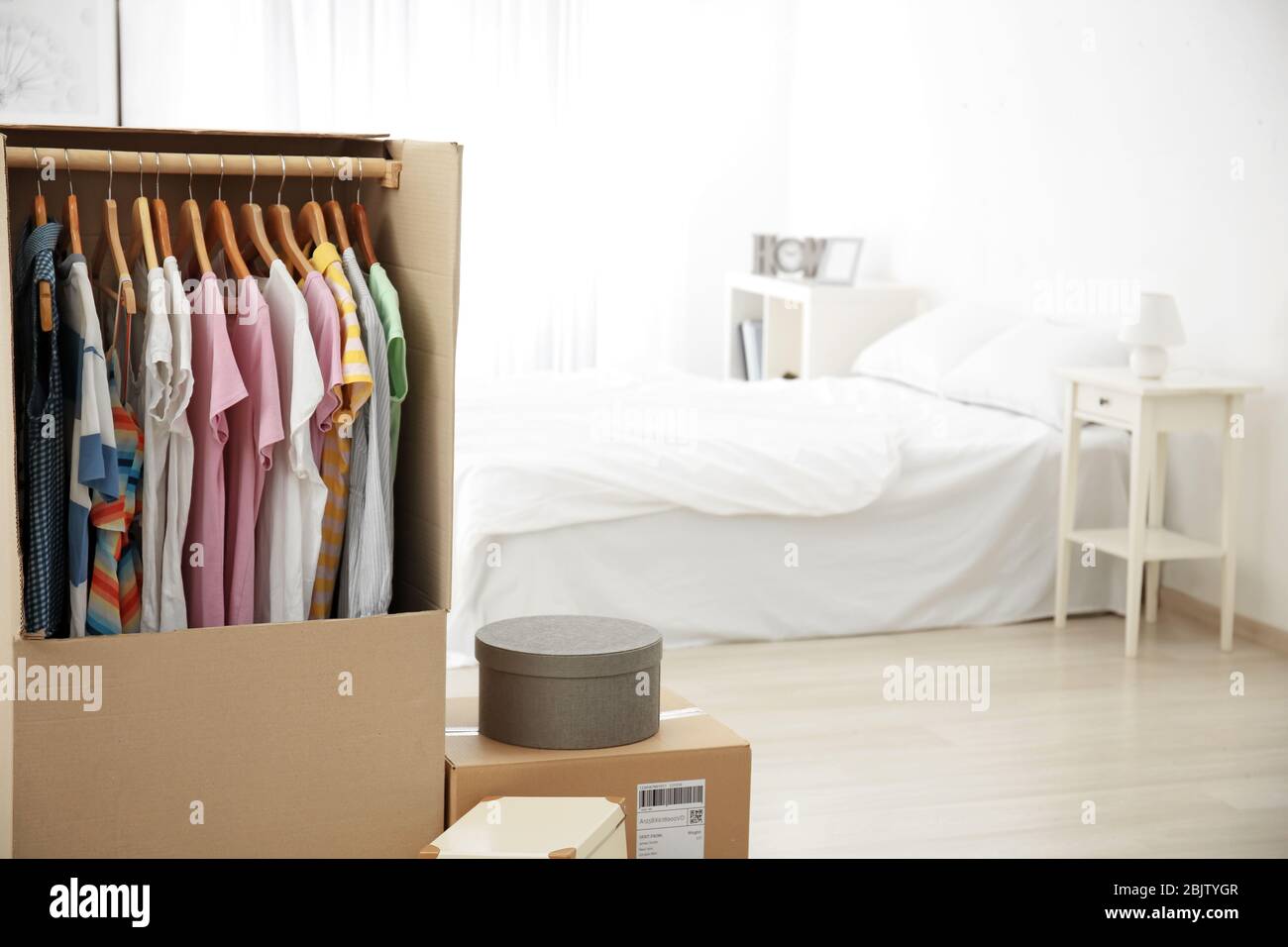 Wardrobe boxes with clothes indoors Stock Photo - Alamy