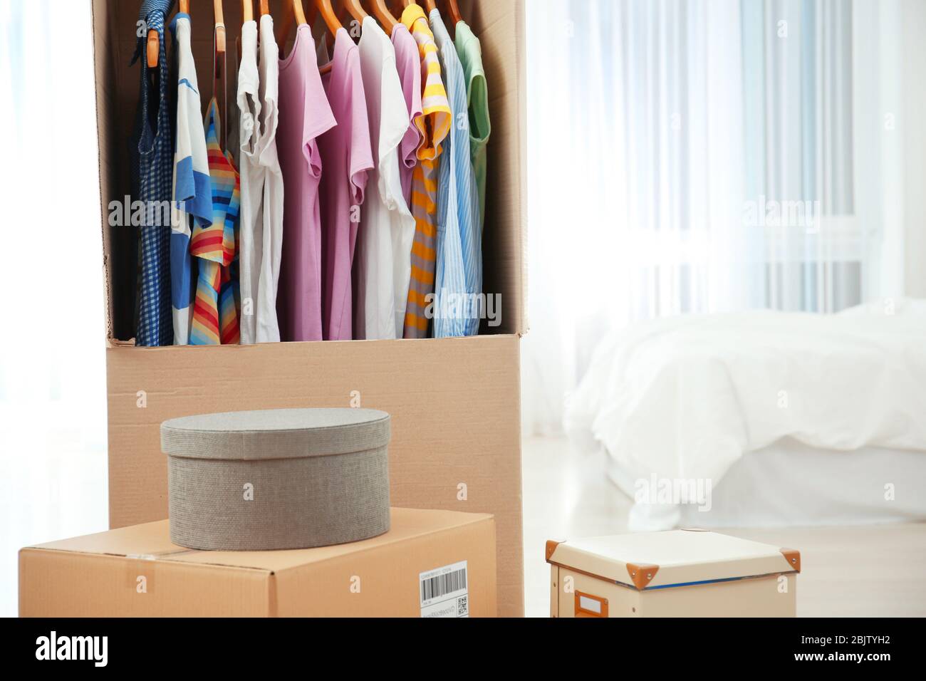 Wardrobe boxes with clothes indoors Stock Photo - Alamy