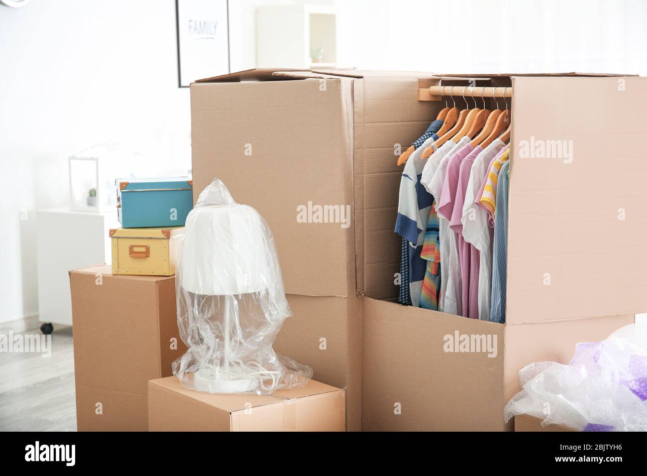 Wardrobe boxes with clothes indoors Stock Photo - Alamy