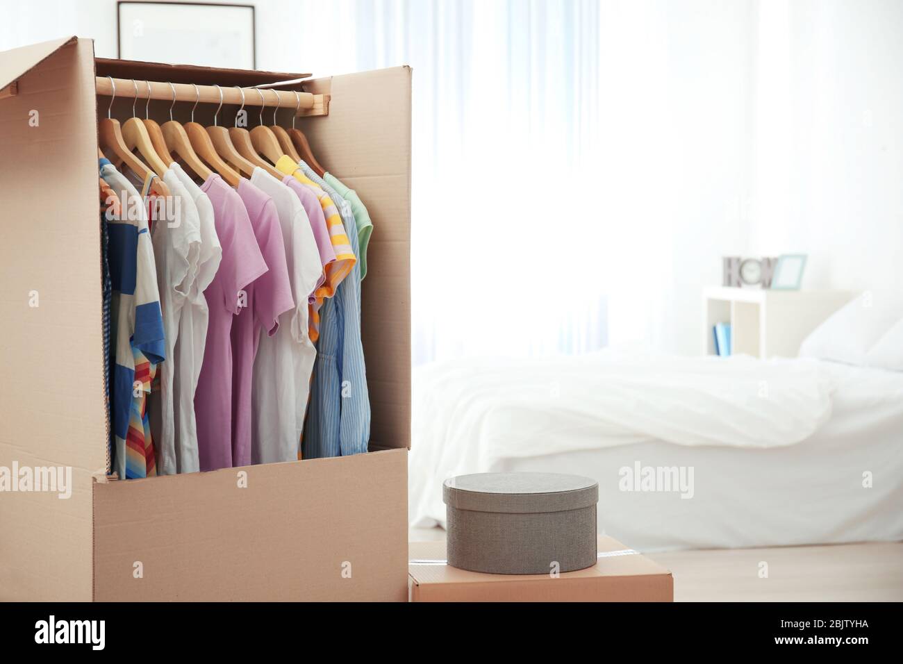 Wardrobe boxes with clothes indoors Stock Photo - Alamy