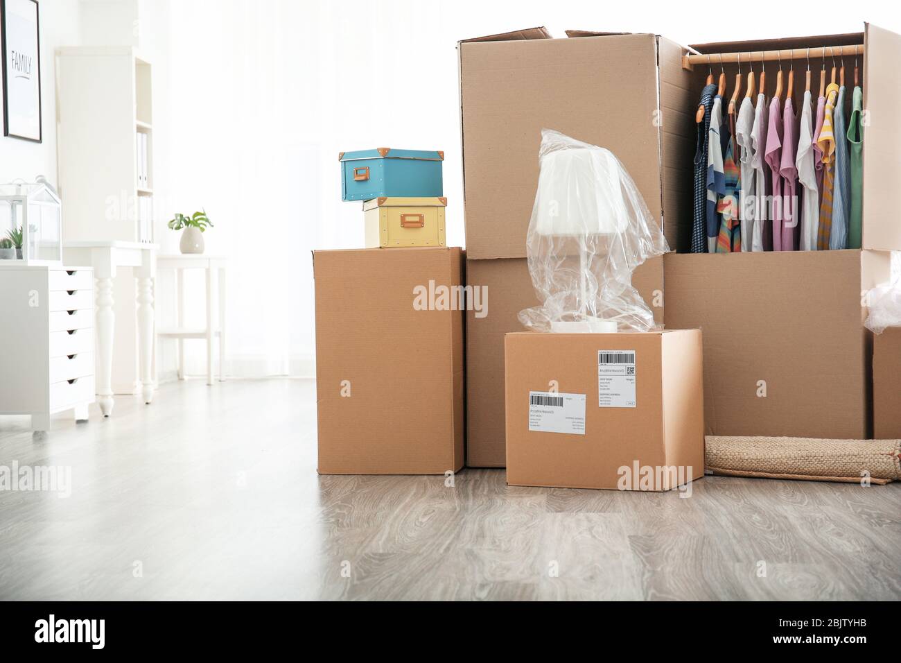 Wardrobe boxes with clothes indoors Stock Photo - Alamy