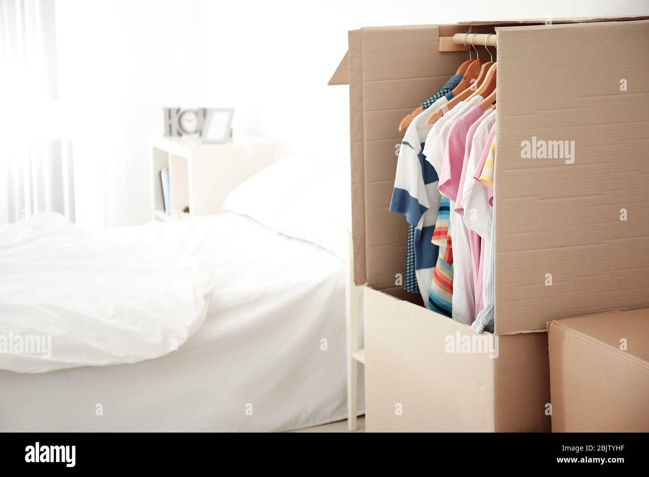 Wardrobe box with clothes indoors Stock Photo - Alamy