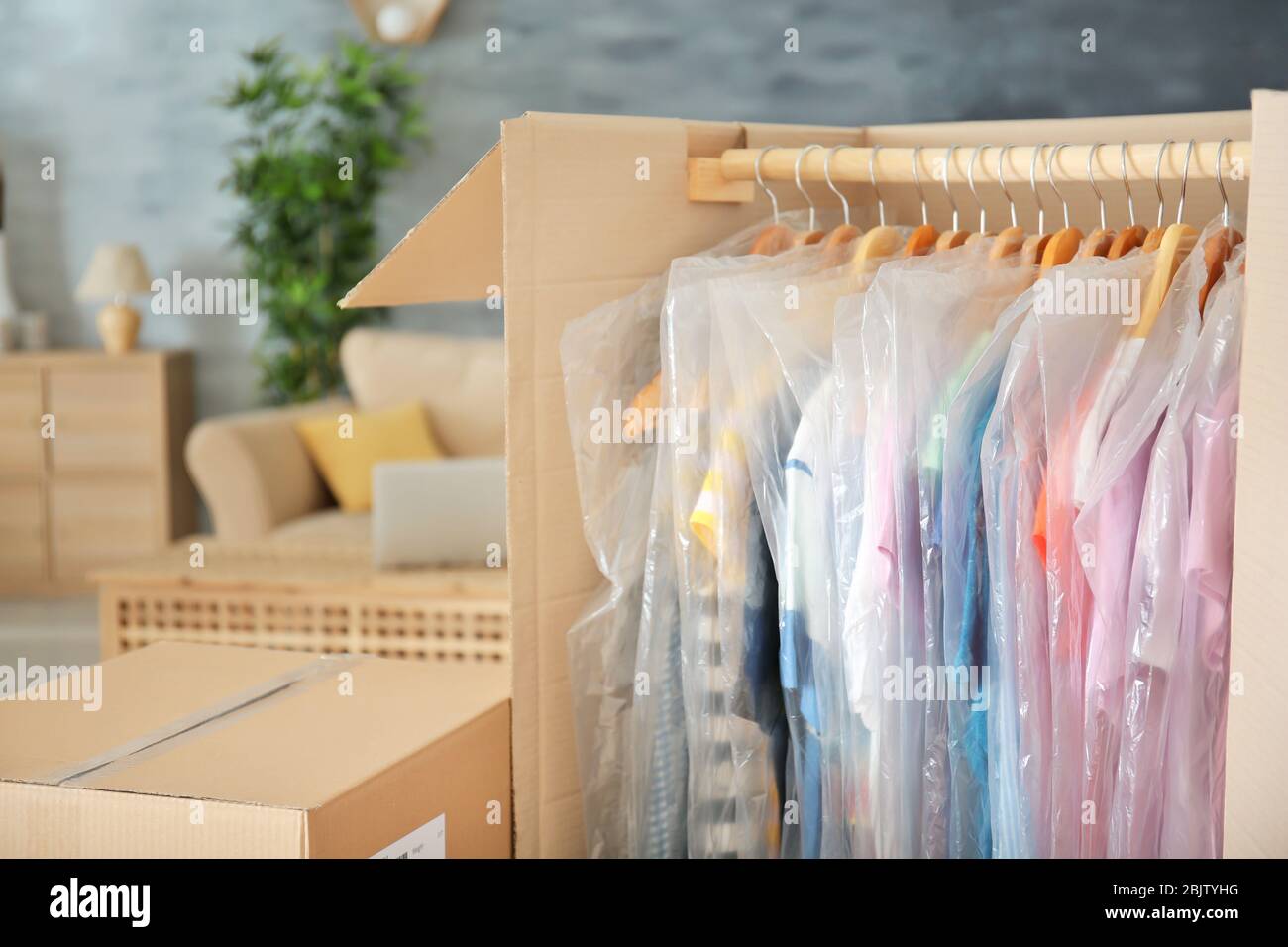 Wardrobe boxes with clothes indoors Stock Photo - Alamy