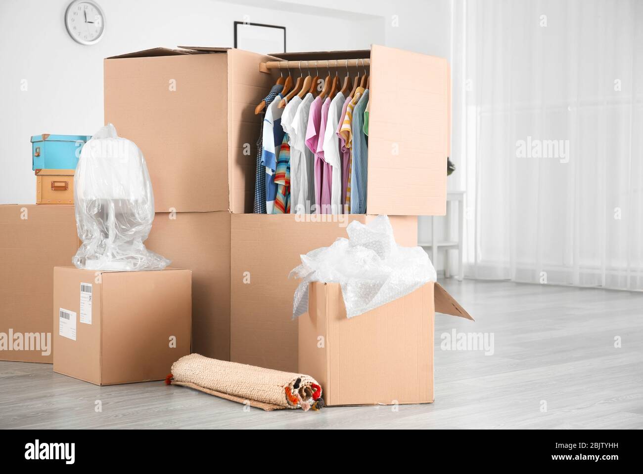 Wardrobe boxes with clothes indoors Stock Photo - Alamy