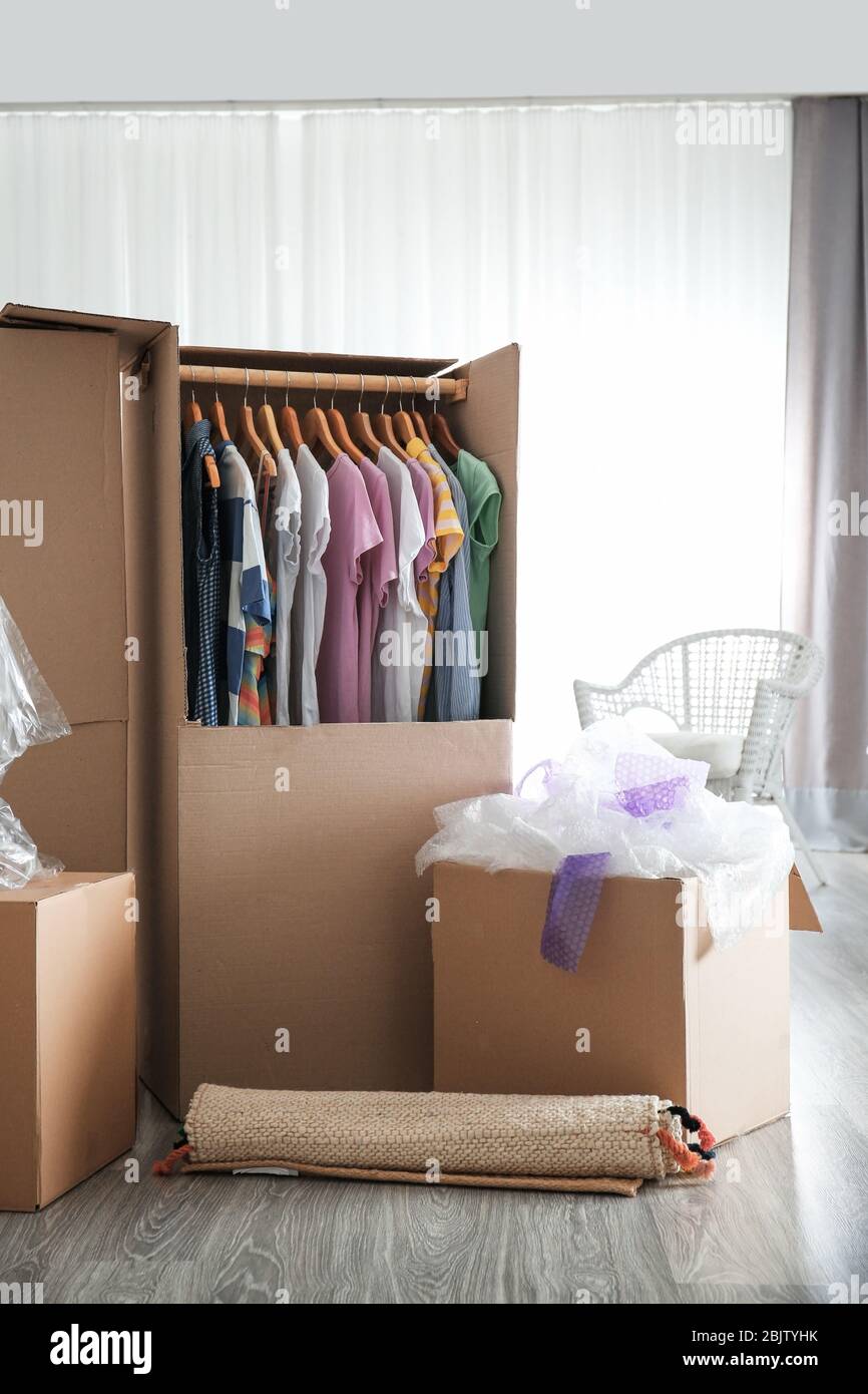 Wardrobe boxes with clothes indoors Stock Photo - Alamy