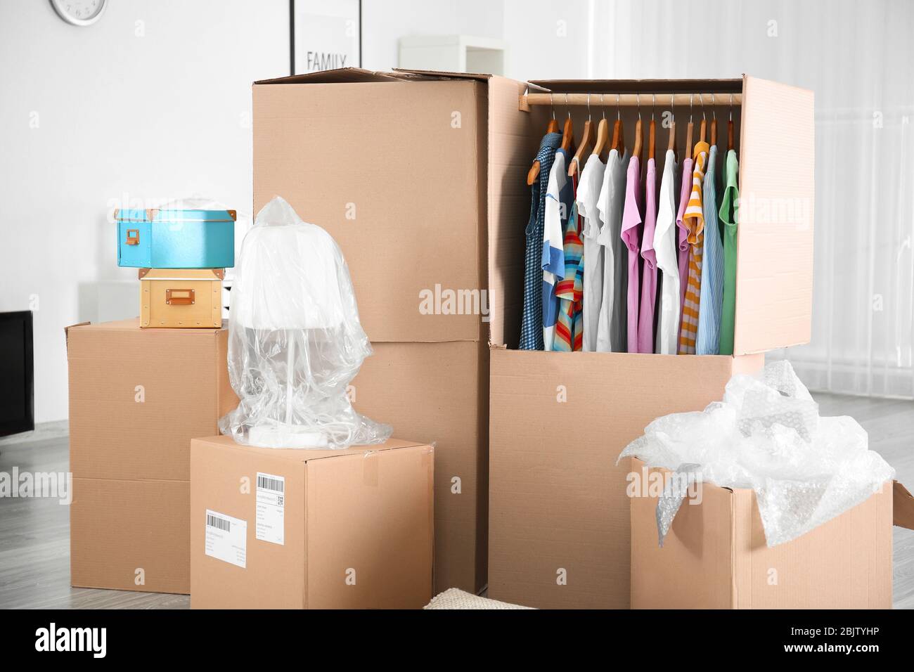 Wardrobe boxes with clothes indoors Stock Photo - Alamy