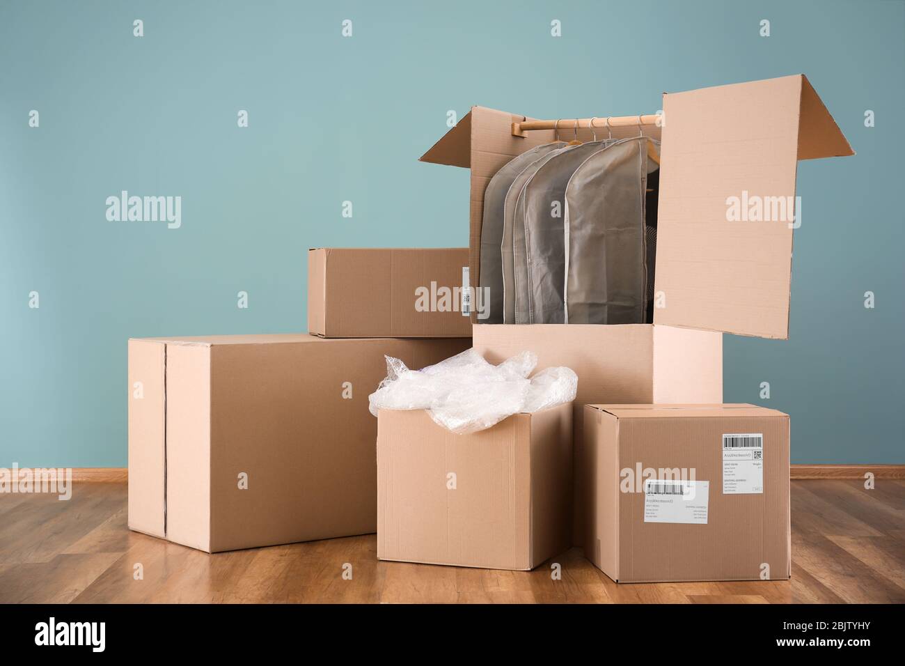 Wardrobe boxes with clothes indoors Stock Photo - Alamy