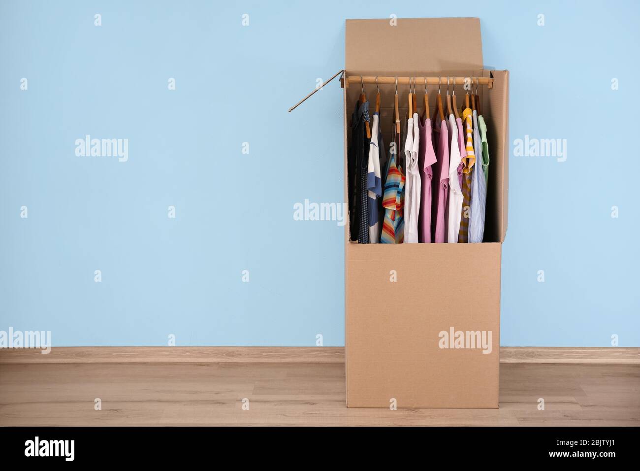 Wardrobe box with clothes indoors Stock Photo - Alamy