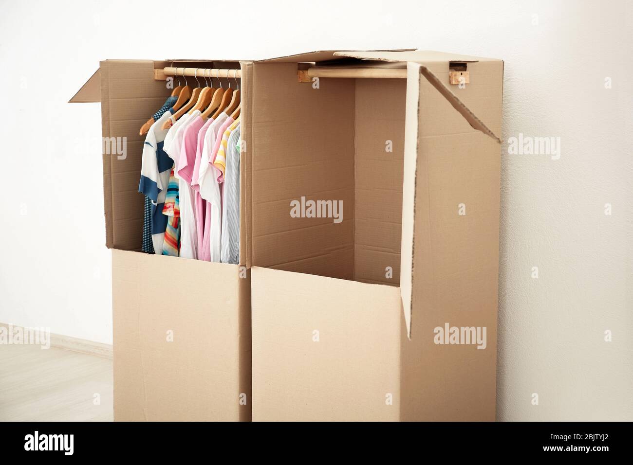 Wardrobe boxes with clothes indoors Stock Photo - Alamy