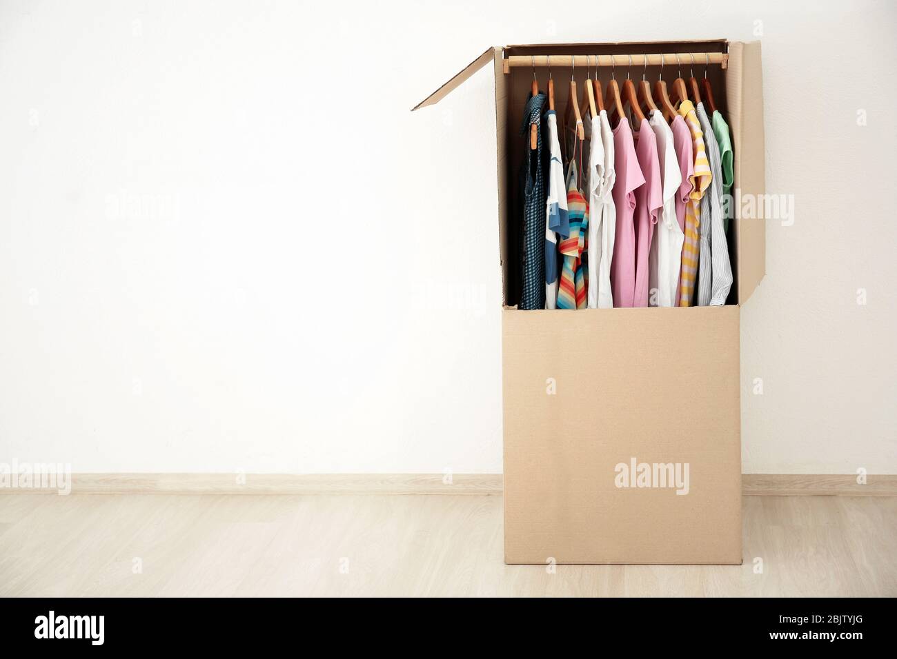 Wardrobe box with clothes indoors Stock Photo - Alamy