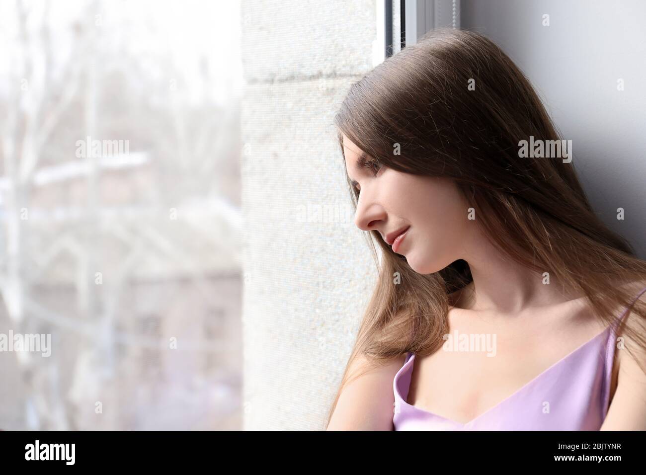 Portrait of beautiful woman near window Stock Photo - Alamy