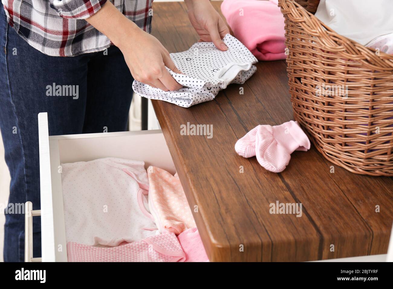 Female folding laundry house hi-res stock photography and images - Alamy