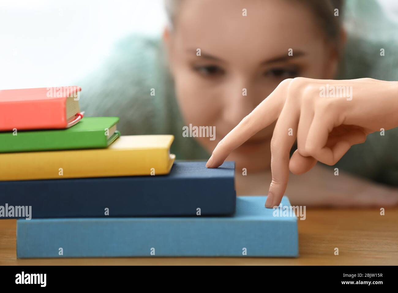 Student with textbooks at table, closeup. Study hard Stock Photo - Alamy