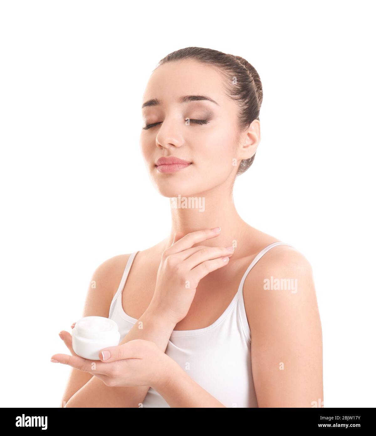 Young woman applying body cream on white background Stock Photo - Alamy