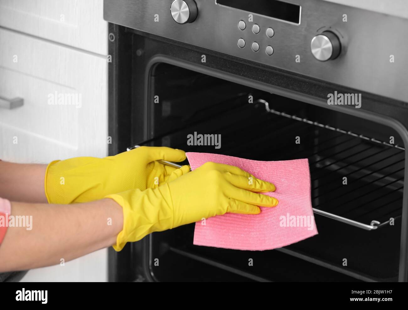 Man cleaning oven in kitchen, closeup Stock Photo - Alamy
