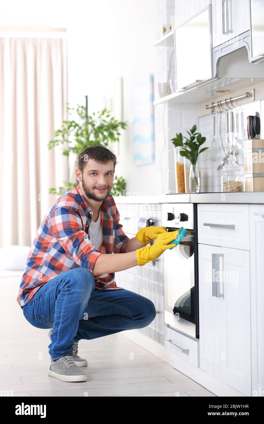 Man cleaning oven in kitchen hi-res stock photography and images - Alamy