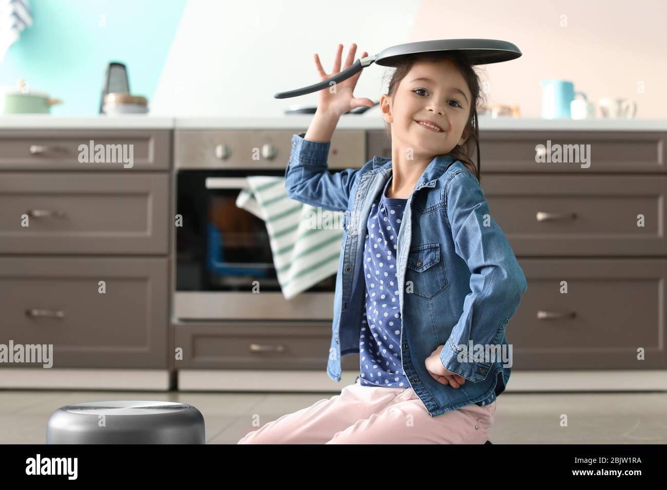 Cute little girl having fun in kitchen Stock Photo - Alamy