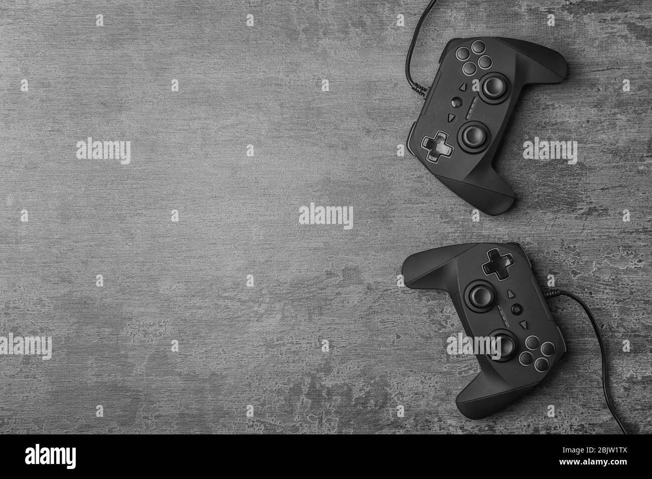 Video game controllers on grey background Stock Photo - Alamy
