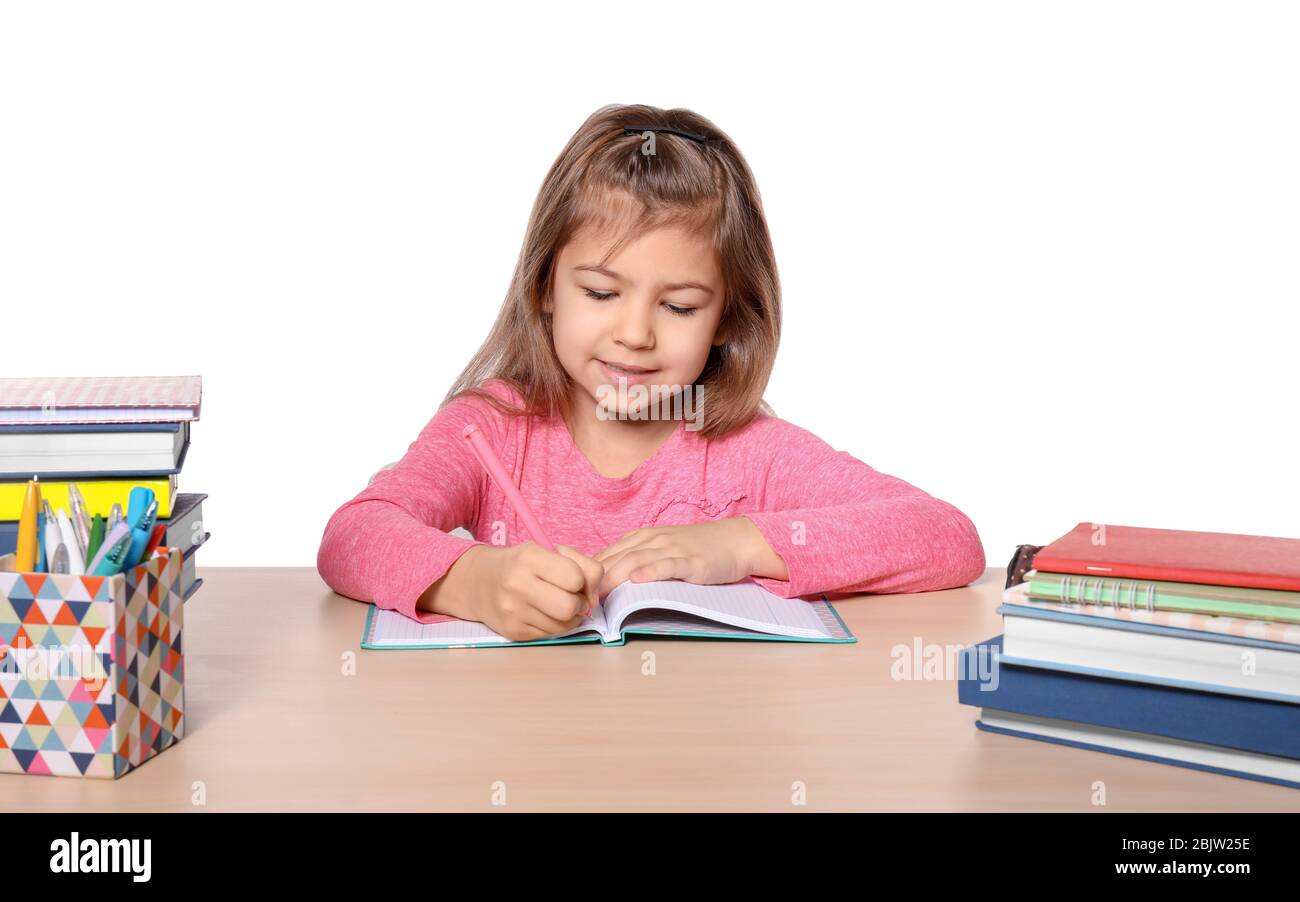 Cute little girl doing homework against white background Stock Photo ...