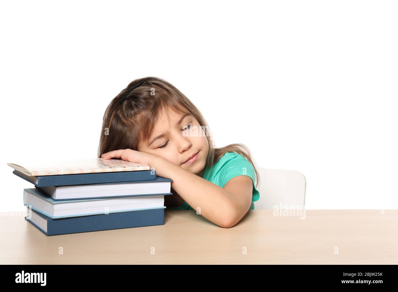 Sleeping little girl tired of doing homework against white background ...