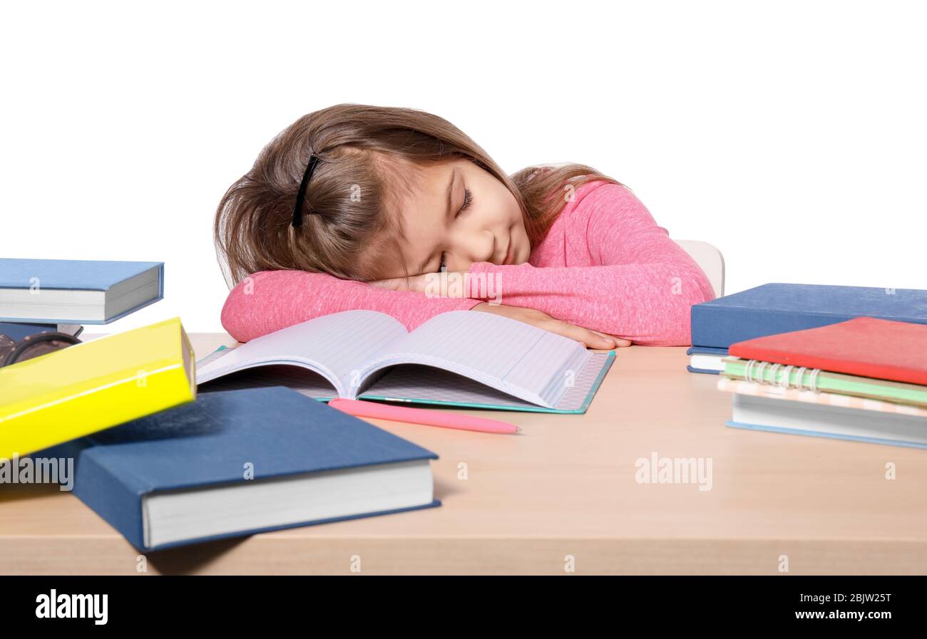 Sleeping little girl tired of doing homework against white background ...