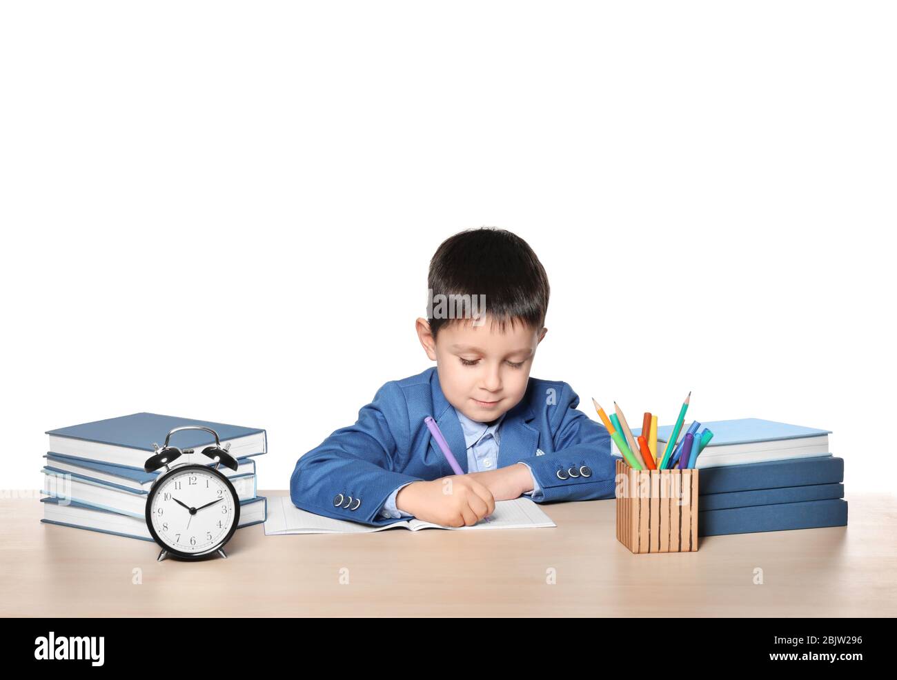 Cute little boy doing homework against white background Stock Photo - Alamy