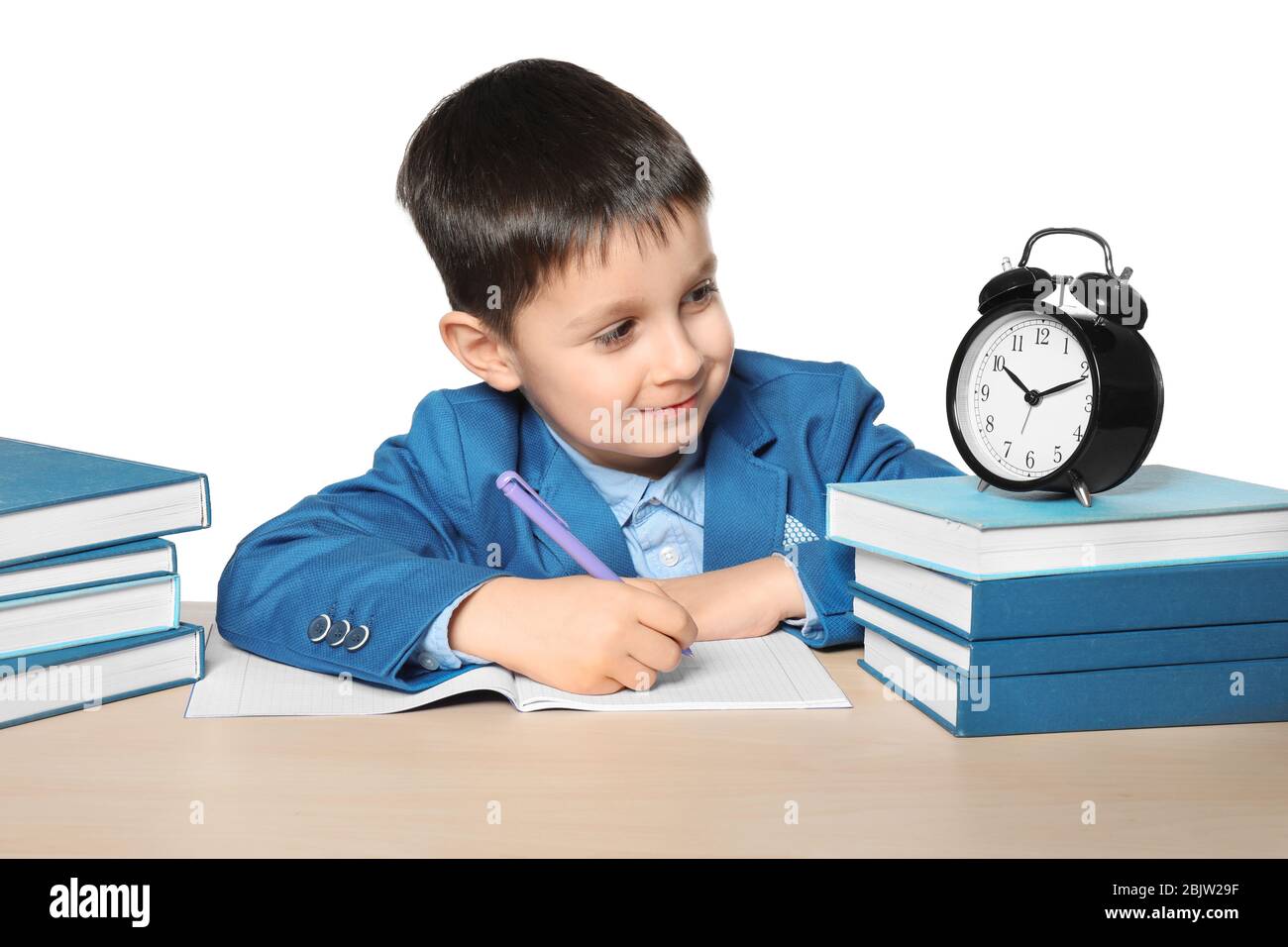 Cute little boy doing homework against white background Stock Photo - Alamy
