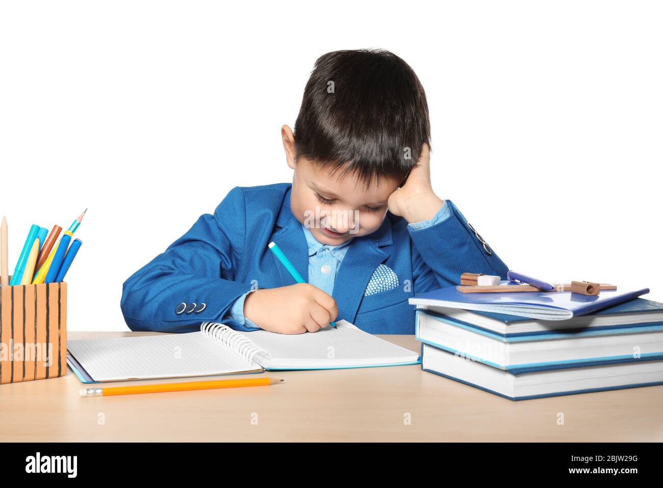 Cute little boy doing homework against white background Stock Photo - Alamy