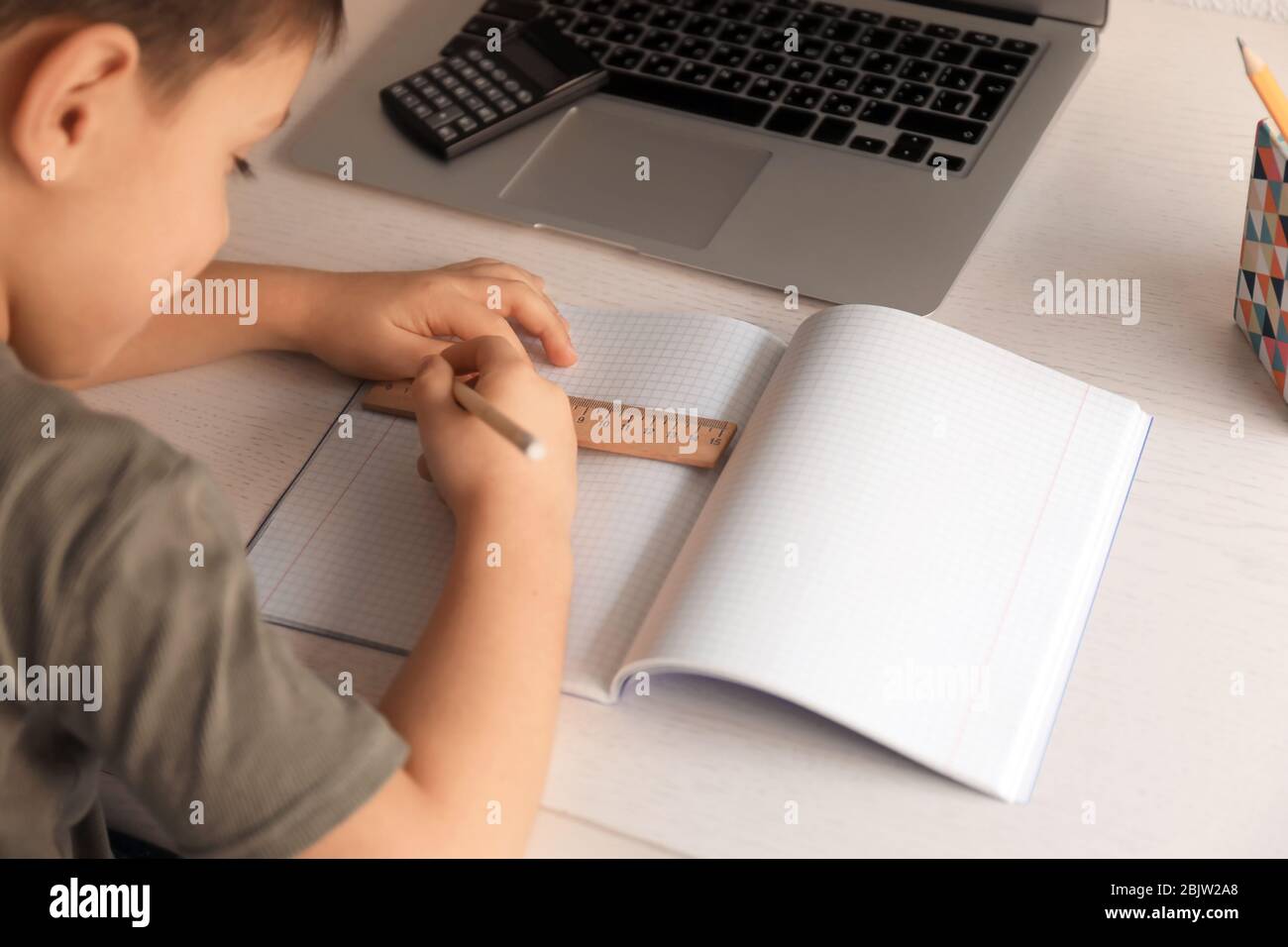 Cute little boy doing homework indoors Stock Photo - Alamy
