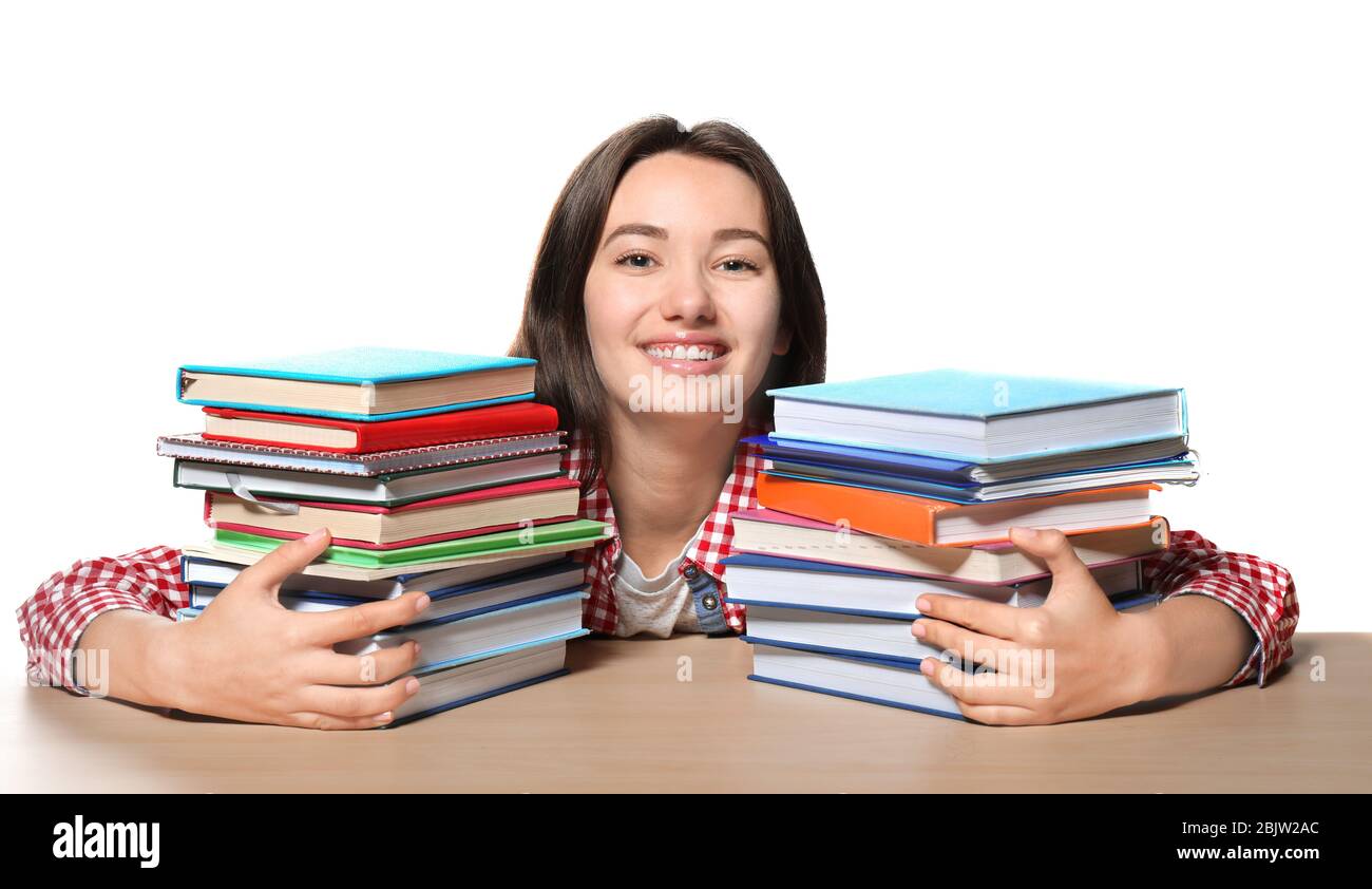 Cute teenager girl with lot of homework to do against white background ...