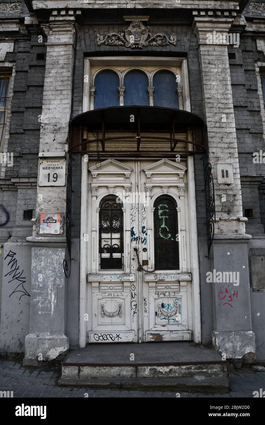 Facade of ancient building with dirty brick wall and columns by sides ...