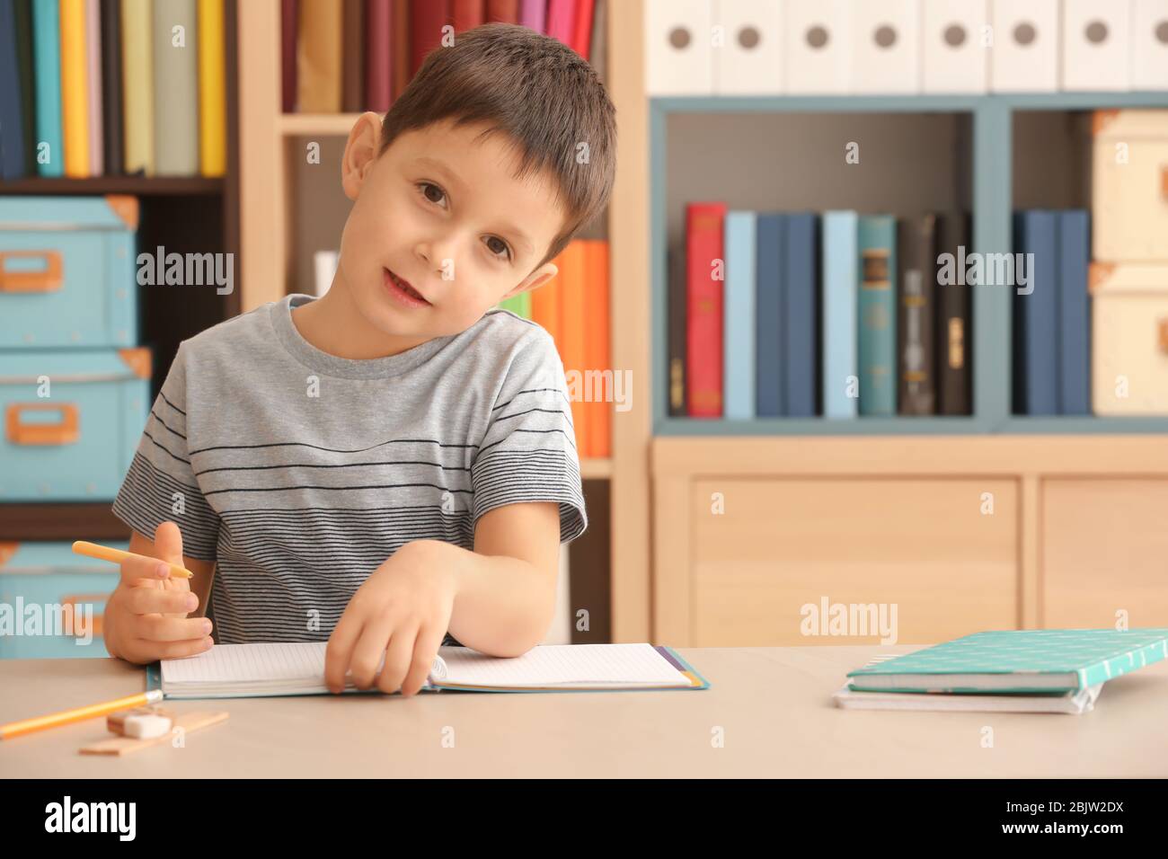 Cute little boy doing homework indoors Stock Photo - Alamy
