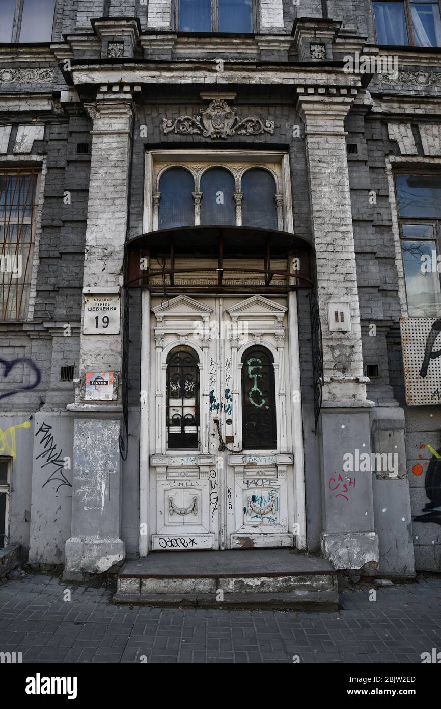 Ancient building with dirty brick wall and columns by sides of white ...