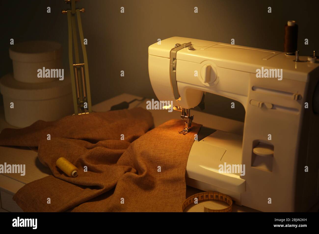 Tailor desk with modern sewing machine Stock Photo - Alamy
