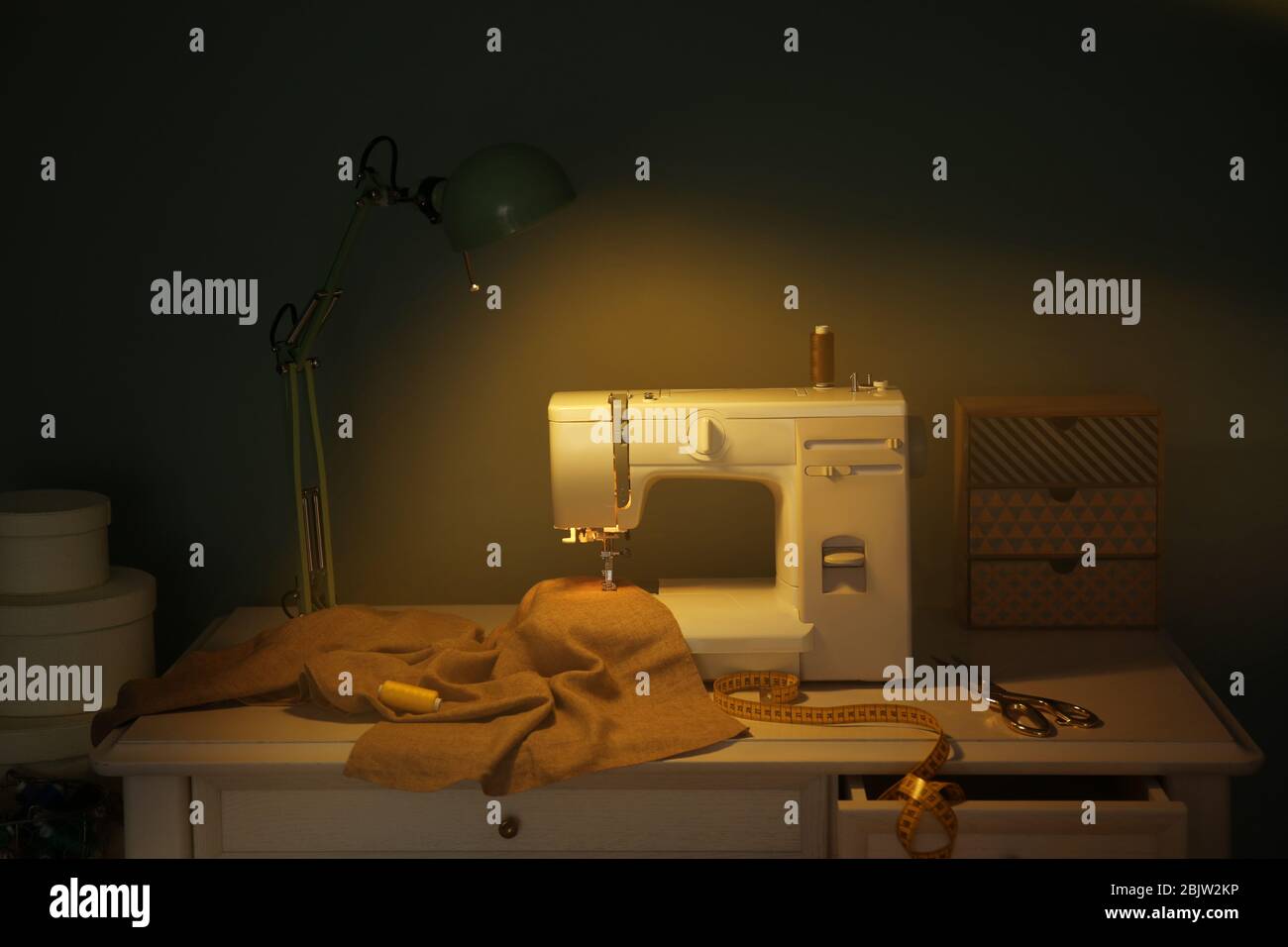 Tailor desk with modern sewing machine Stock Photo - Alamy