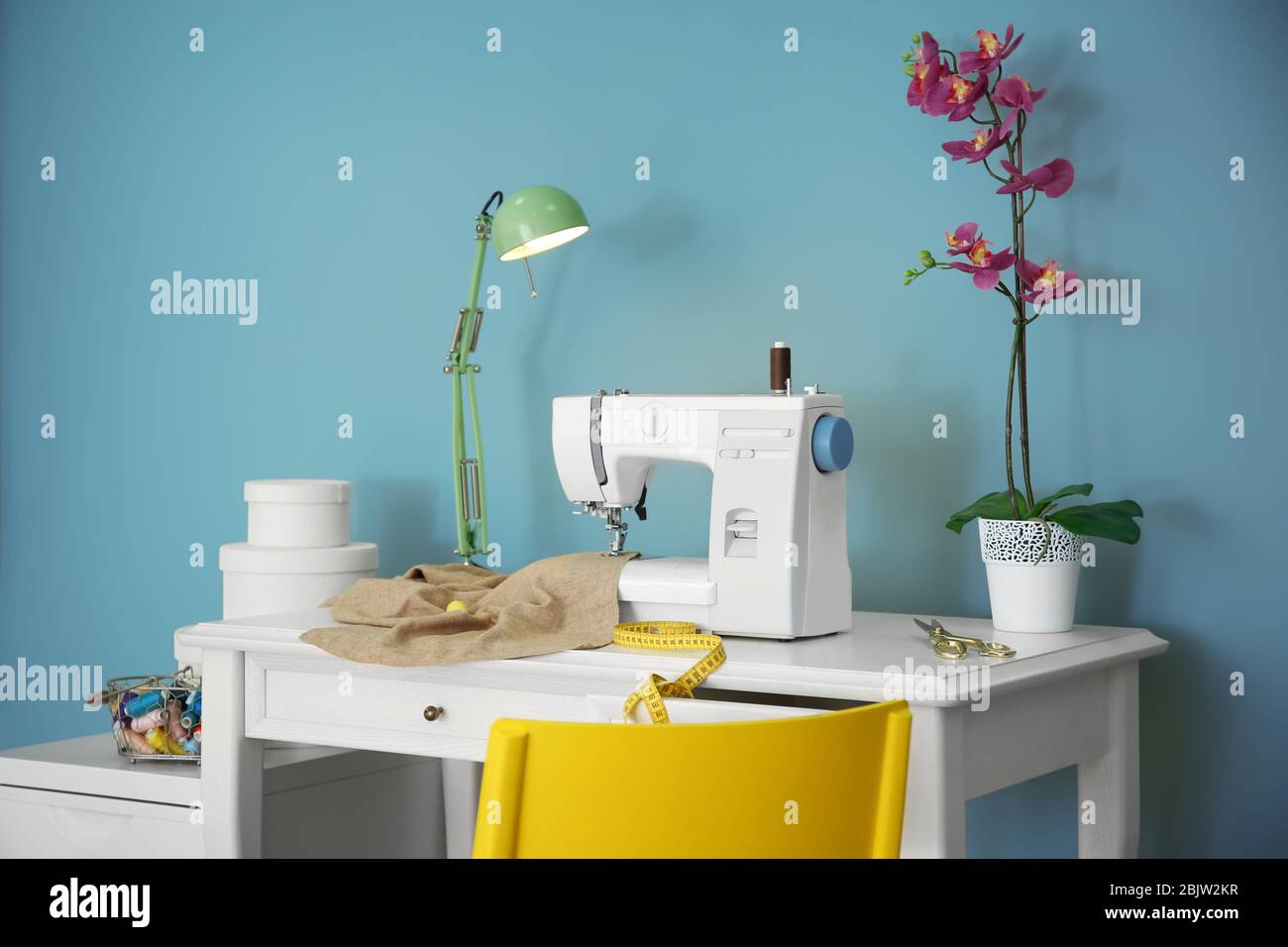 Tailor desk with modern sewing machine Stock Photo - Alamy