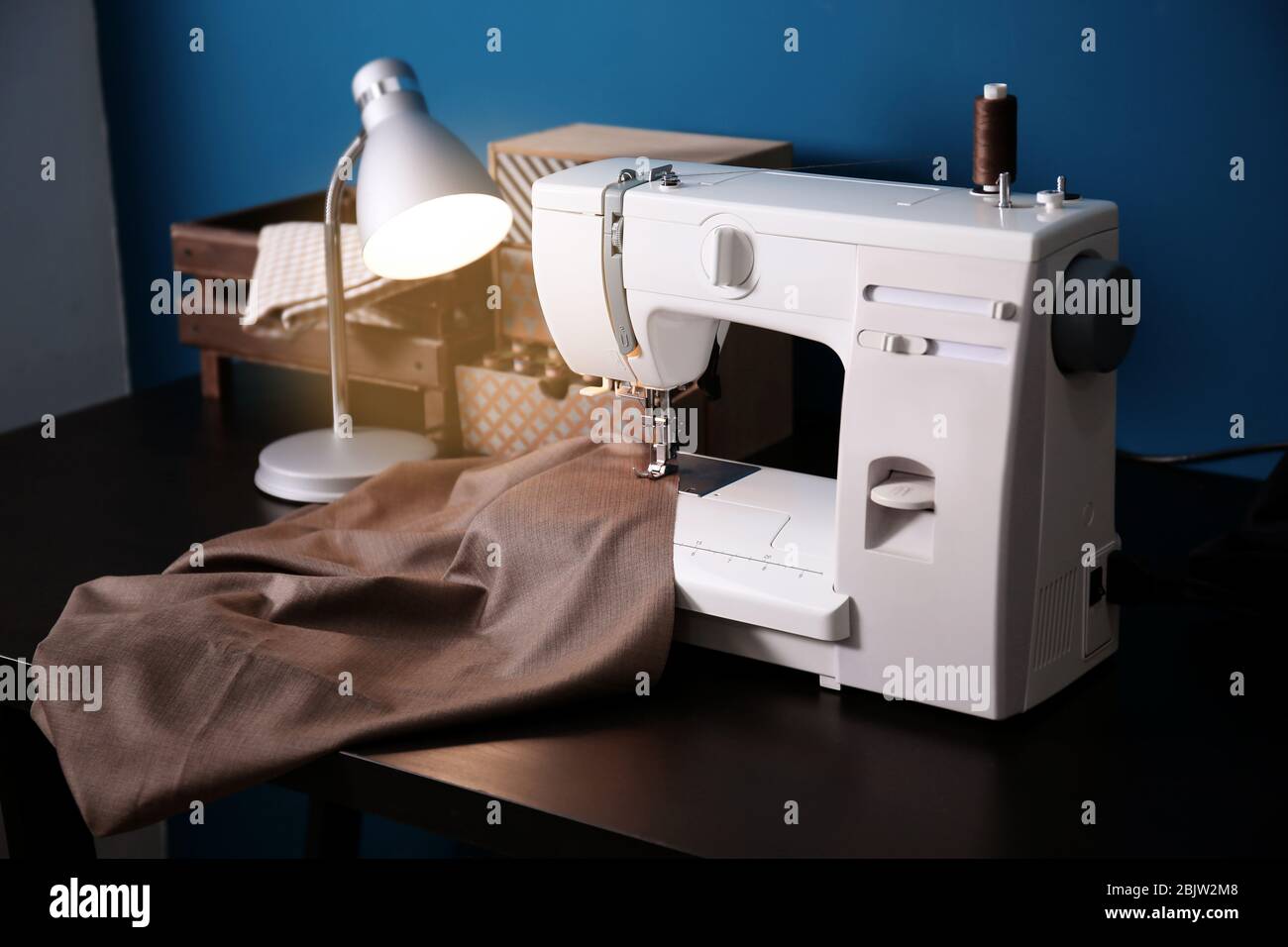 Tailor desk with modern sewing machine Stock Photo - Alamy