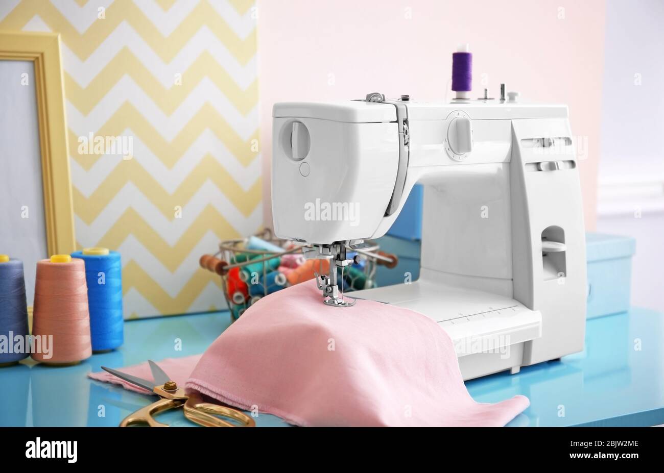 Tailor desk with modern sewing machine Stock Photo - Alamy
